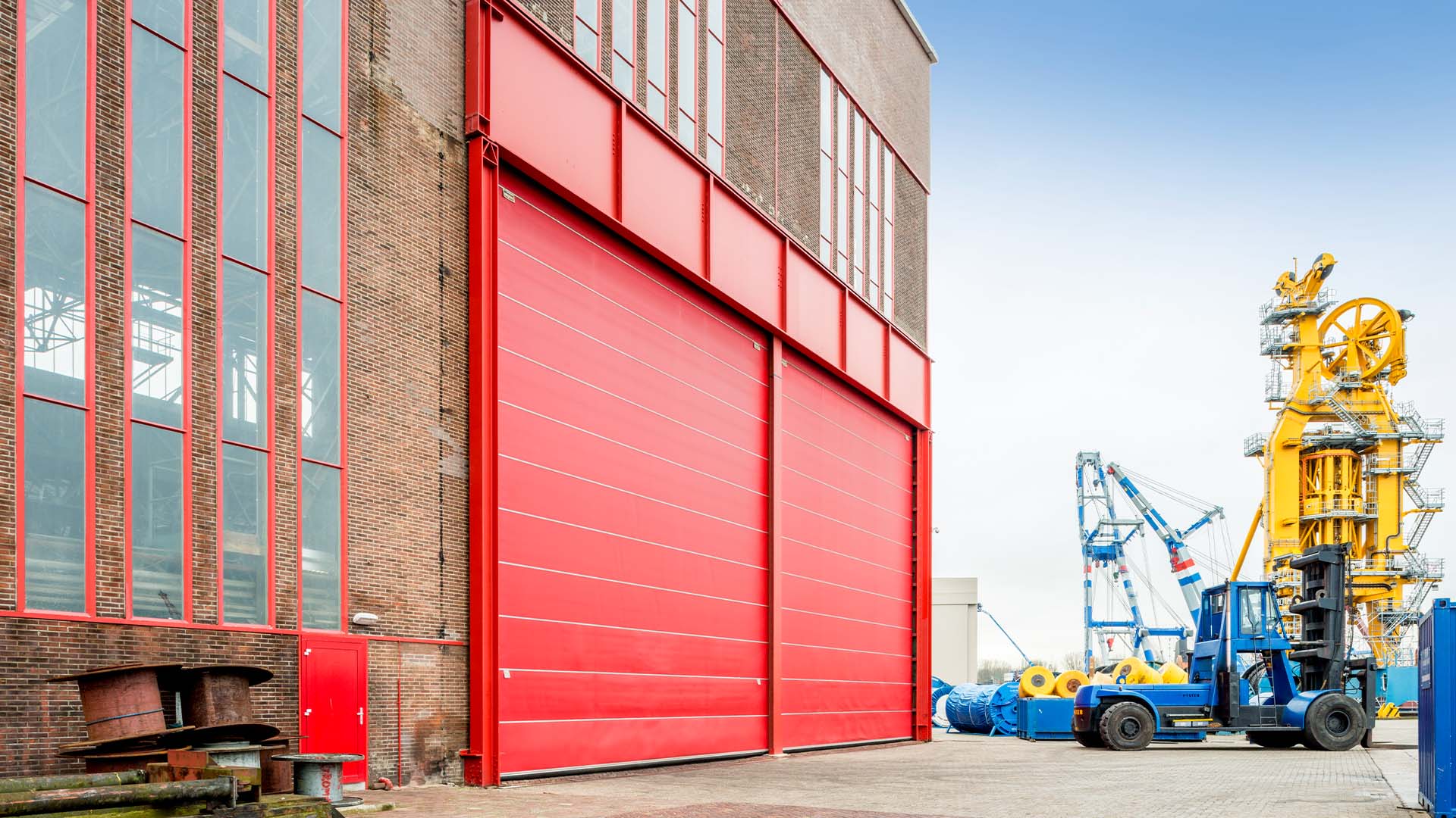 Vertical lifting fabric doors for extremely large openings